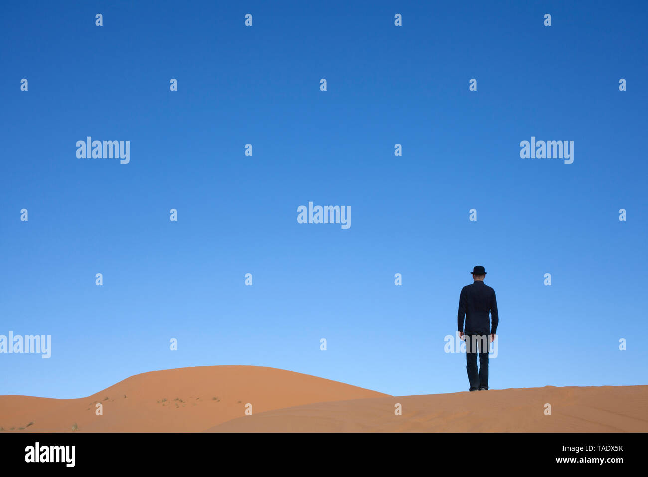 Morocco, Merzouga, Erg Chebbi, rear view of man wearing a bowler hat ...
