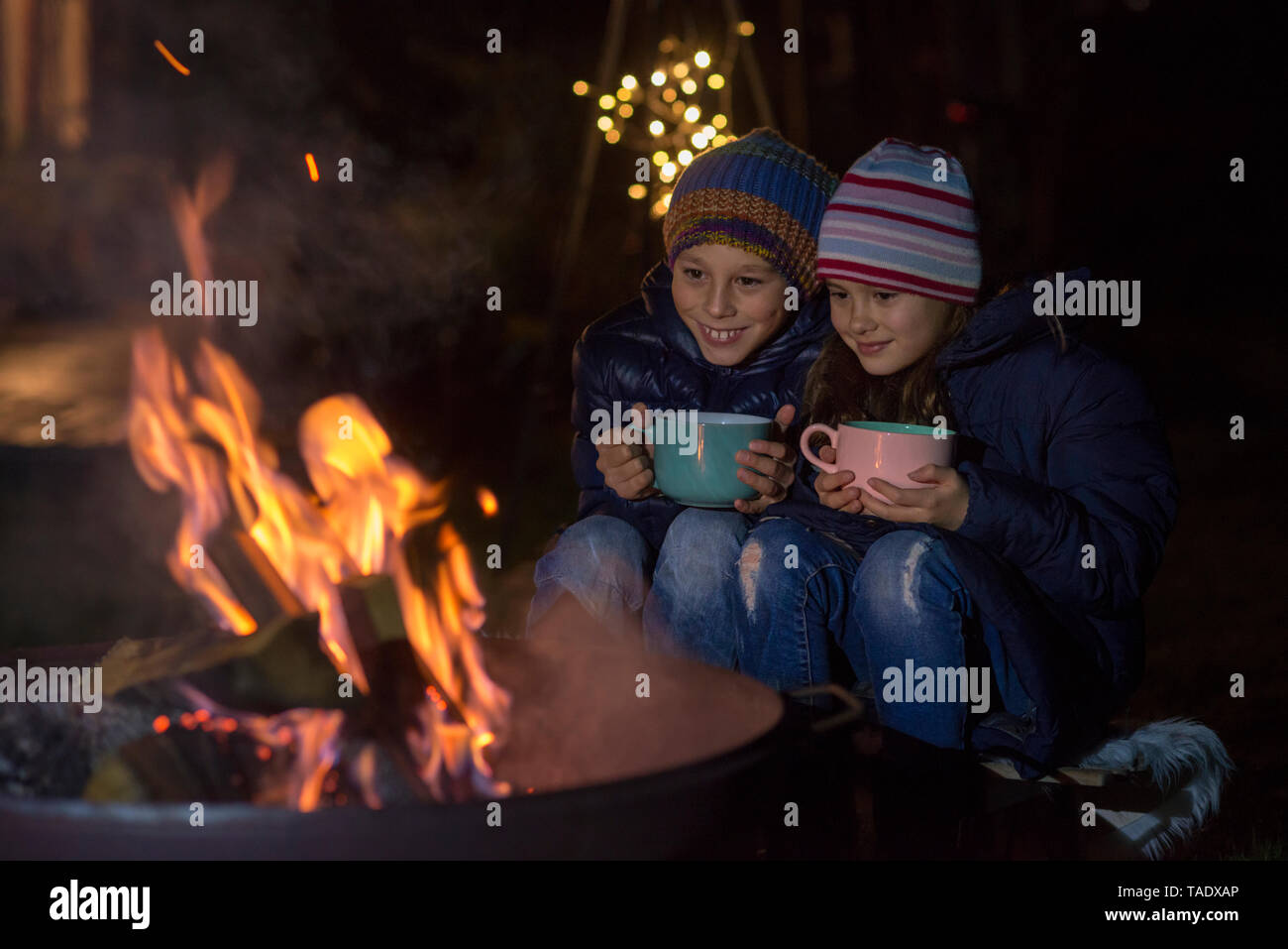 Children sitting by the fire hi-res stock photography and images - Alamy