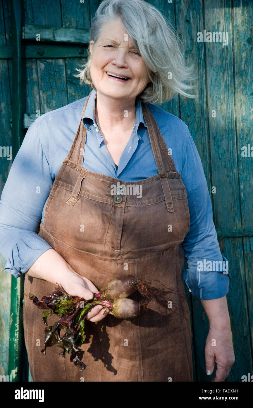 Senior woman harvesting beetroot hi-res stock photography and images ...