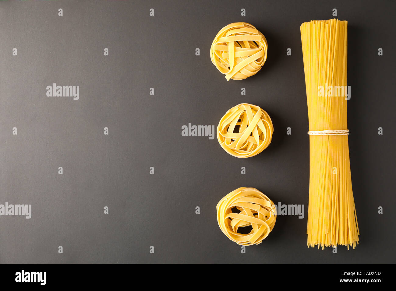 Flat lay composition with pasta on black background, space for text ...
