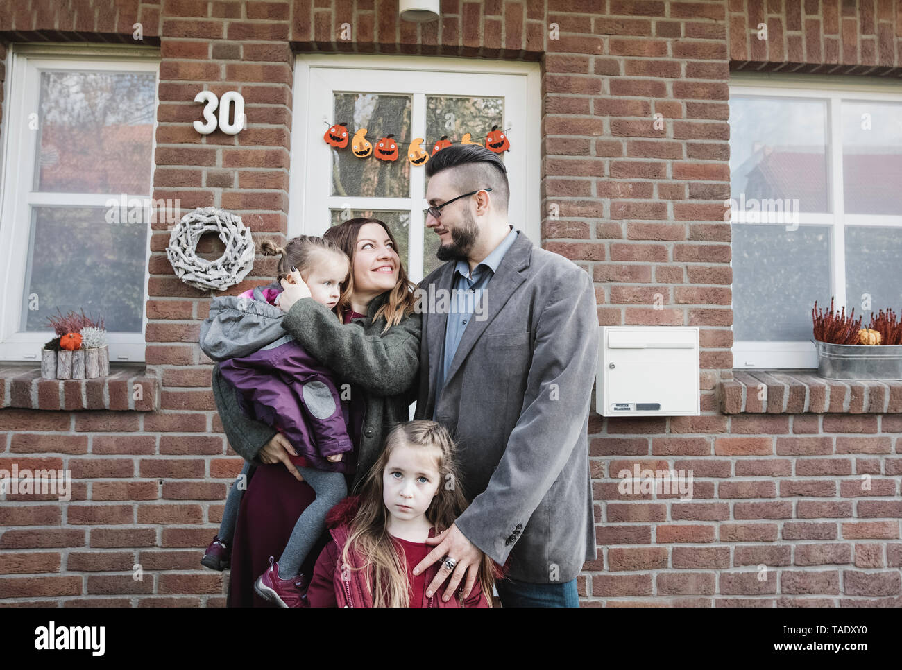 Portrait of family in front of their house Stock Photo - Alamy