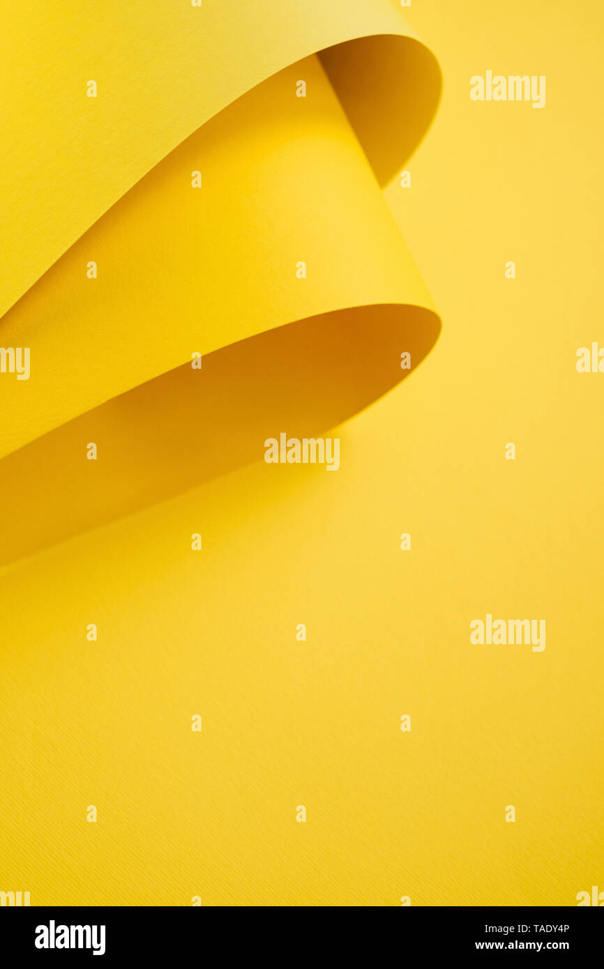 Yellow folded papers as background Stock Photo - Alamy