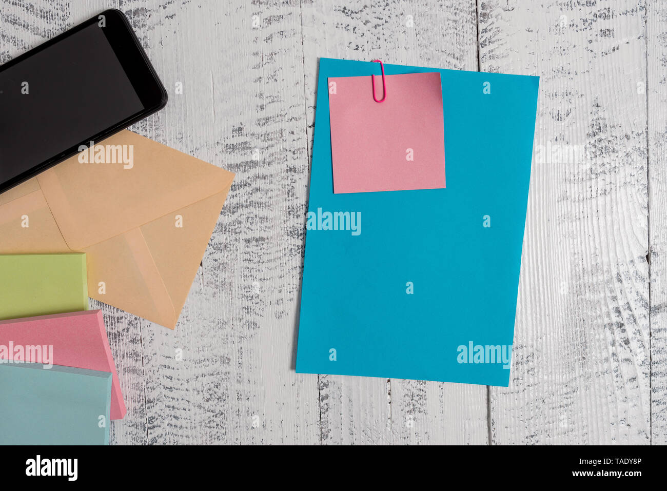 Envelope paper sheet note smartphone notepads wooden vintage background ...