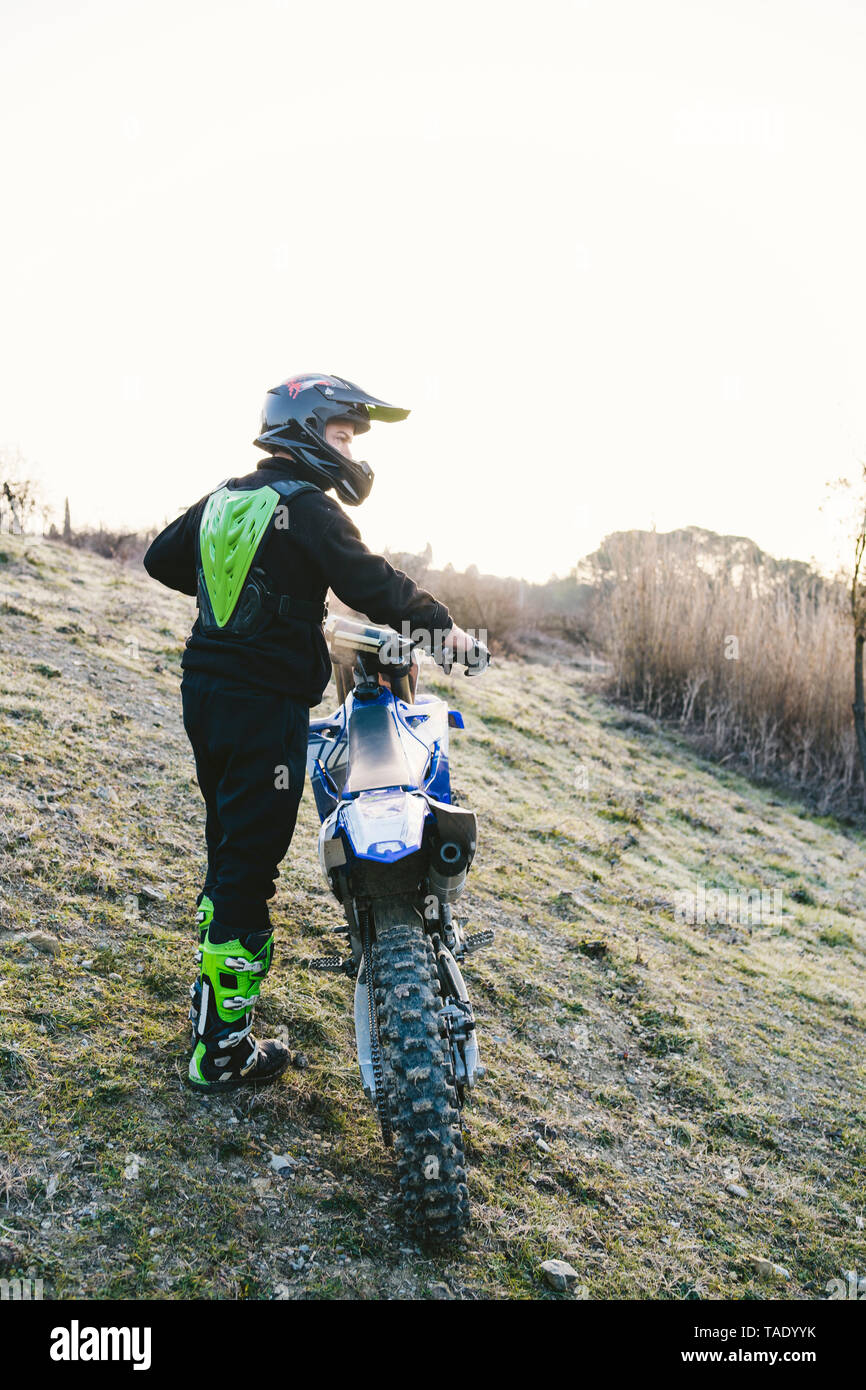 Motocross driver standing on circuit Stock Photo - Alamy