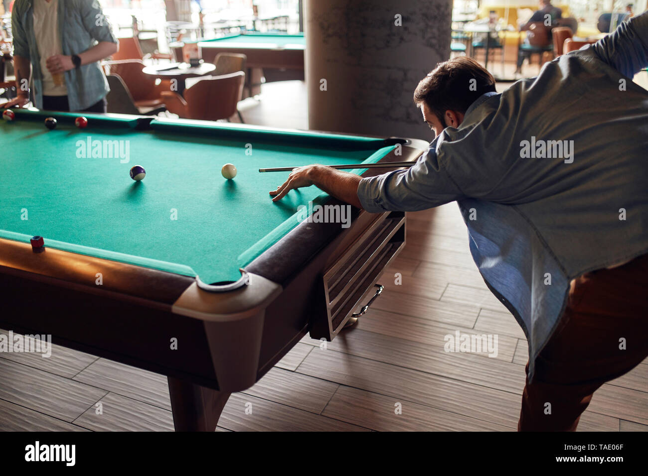 Young man bending over table hi-res stock photography and images - Alamy