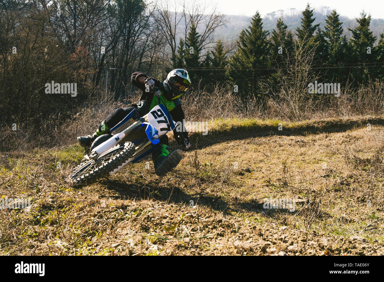 Motocross driver riding on circuit Stock Photo - Alamy