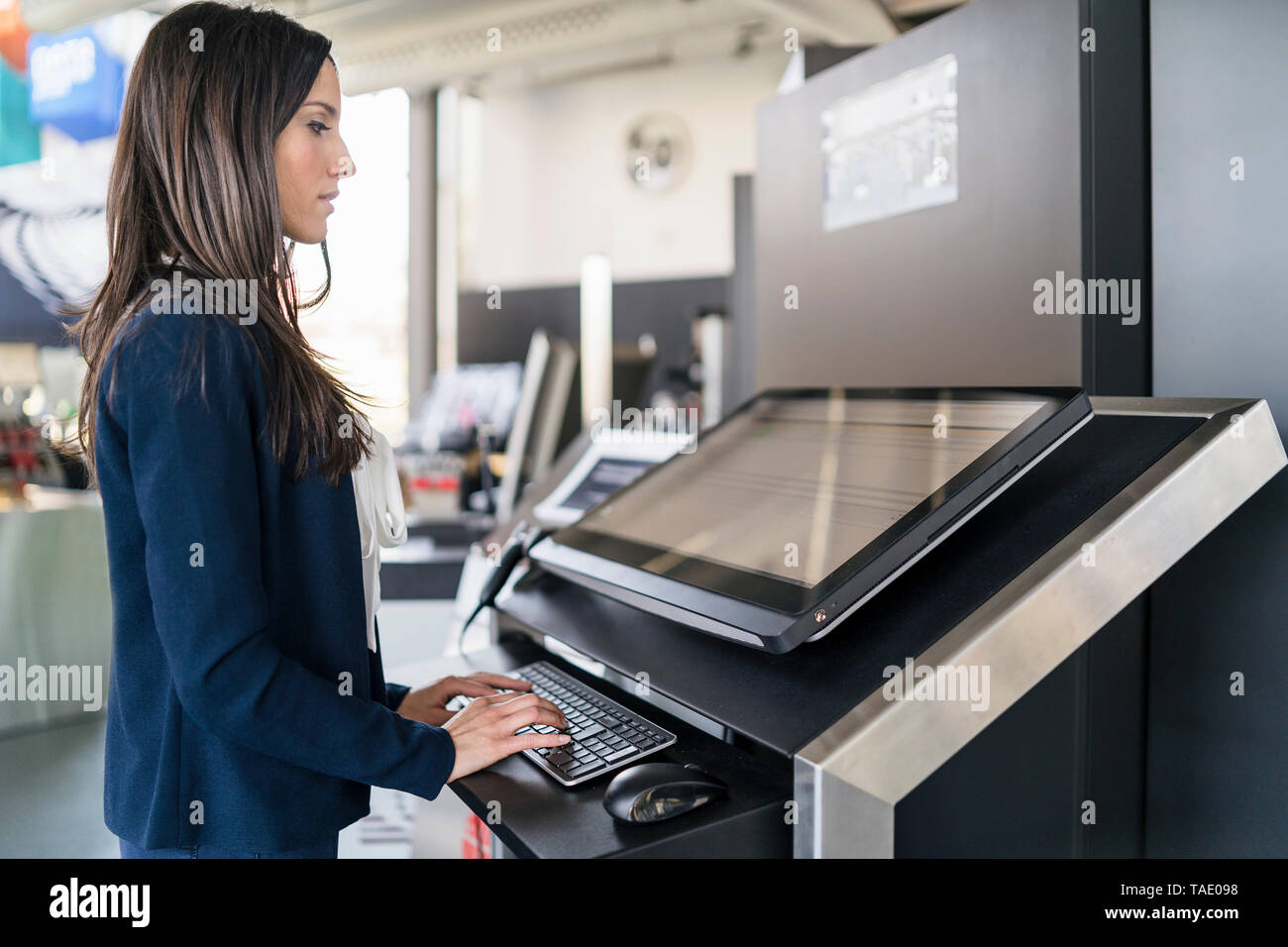 Businesswoman operating machine in a modern factory Stock Photo - Alamy