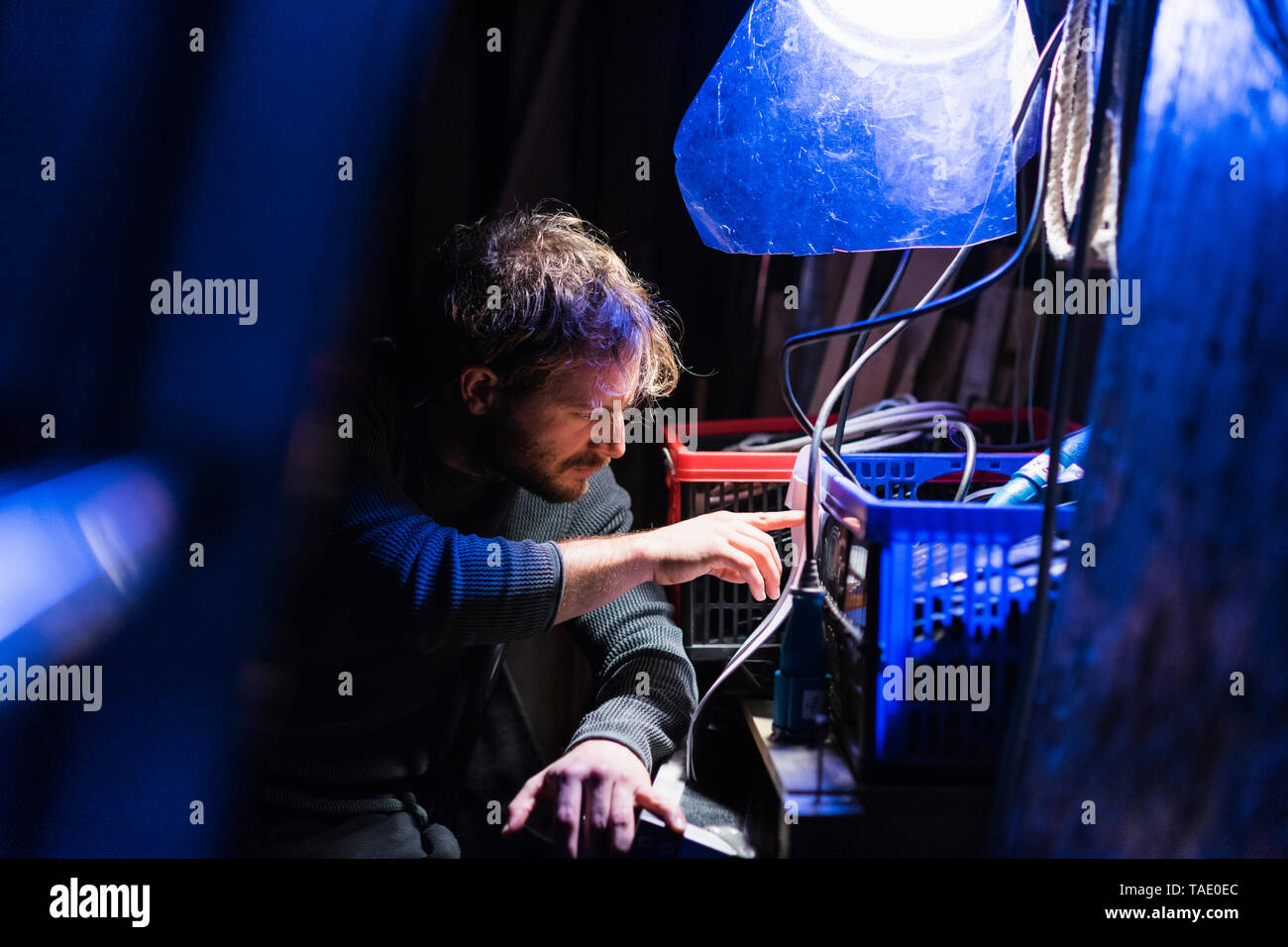 Man sitting backstage at theatre looking at script Stock Photo - Alamy