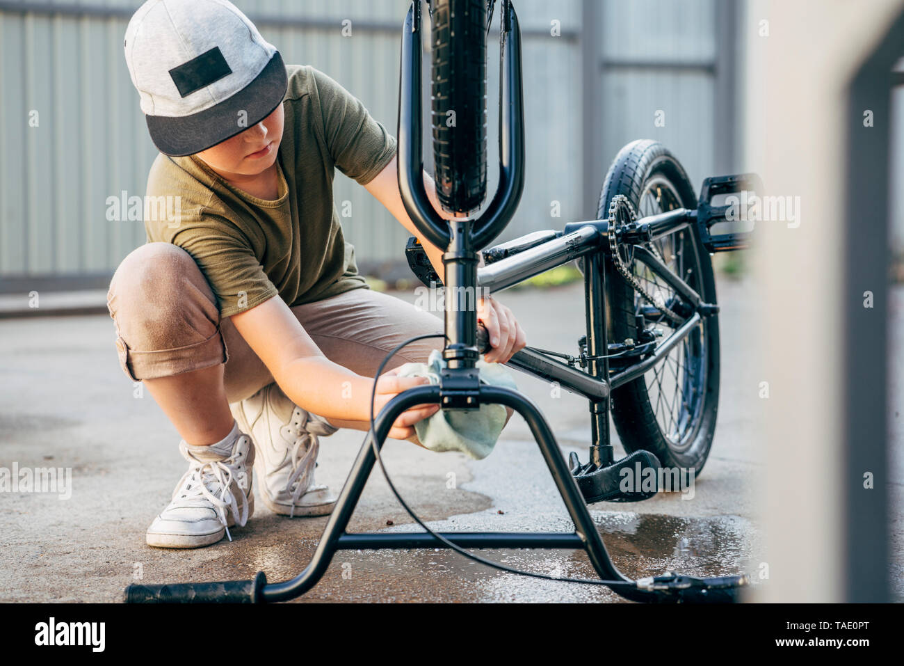 Boy cleaning bmx bike on yard Stock Photo - Alamy