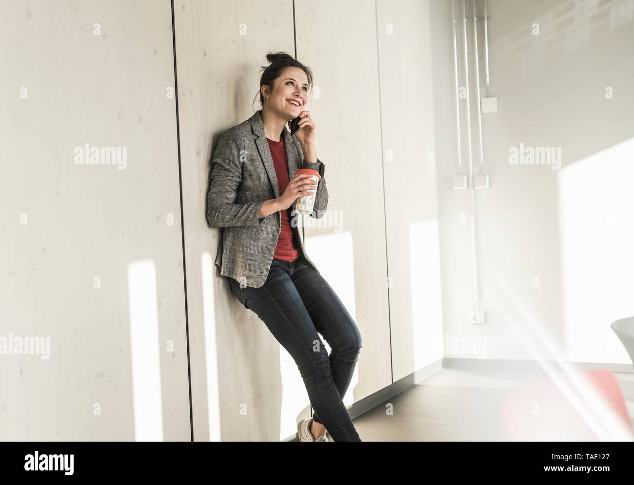 Women leaning against wall on hi-res stock photography and images - Alamy