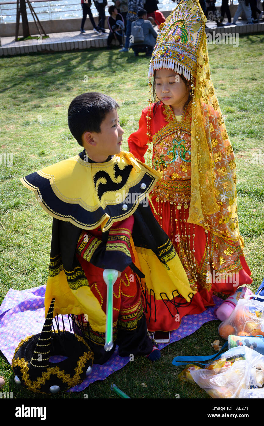 Children playing, dressed in traditional clothes in Kunming, Yunnan ...
