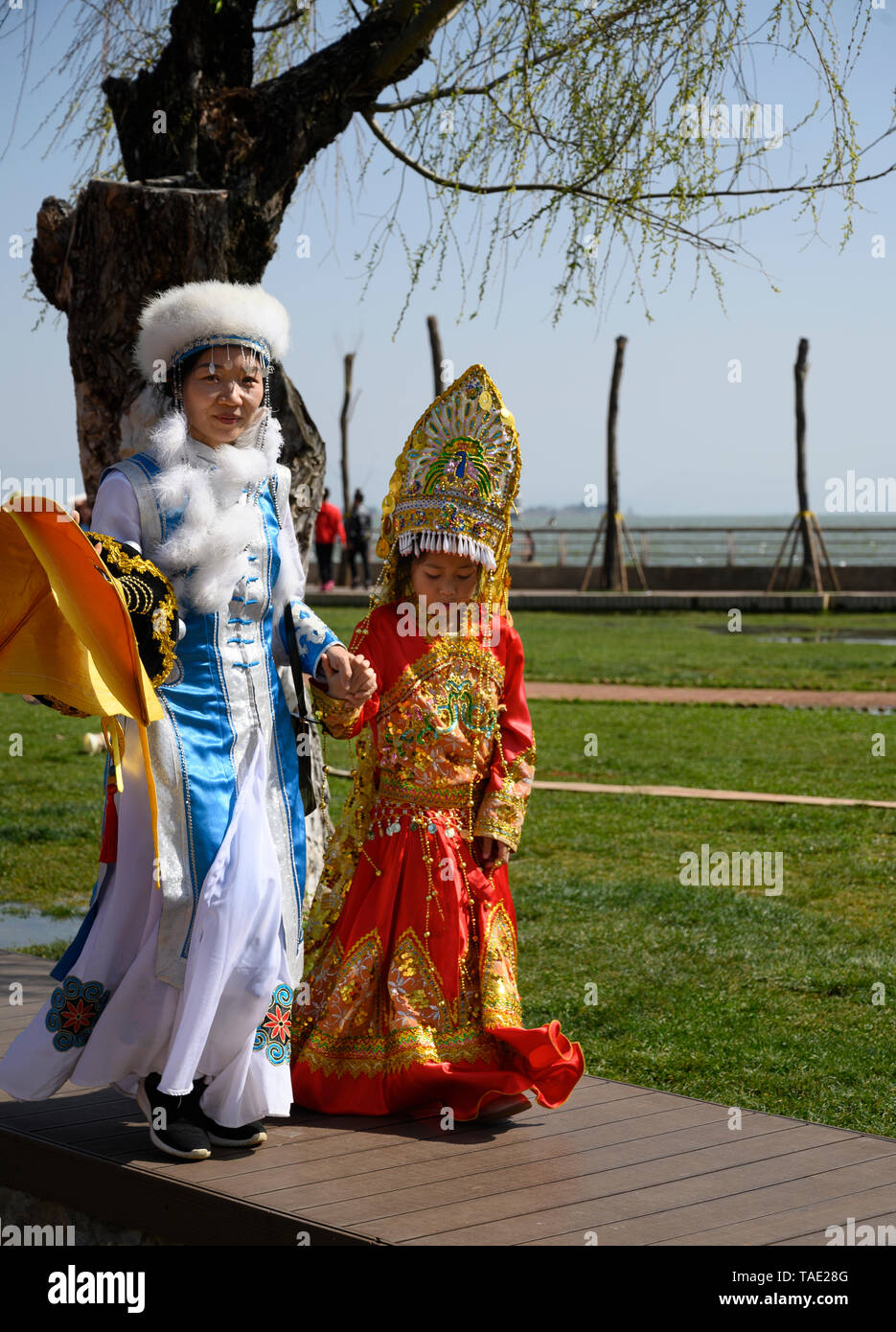 Mother and boy dressed in traditional clothes in Kunming, Yunnan, China ...
