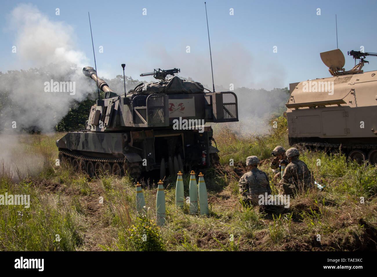 A 2nd Battalion, 142nd Field Artillery Brigade M109 Paladin crew fires a round during a live ...