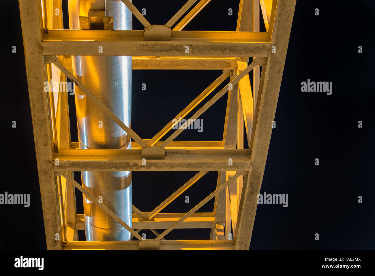Steel support of boiler pipe in the factory on blue dark night sky ...