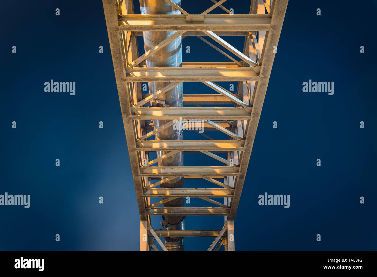 Steel support of boiler pipe in the factory on blue dark night sky ...
