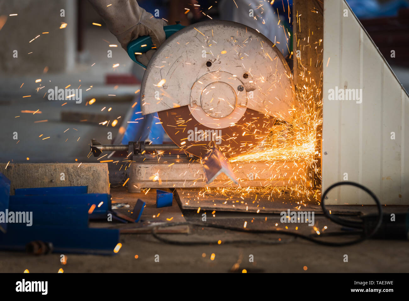 Industrial worker cutting metal with many sharp sparks. Selection focus ...