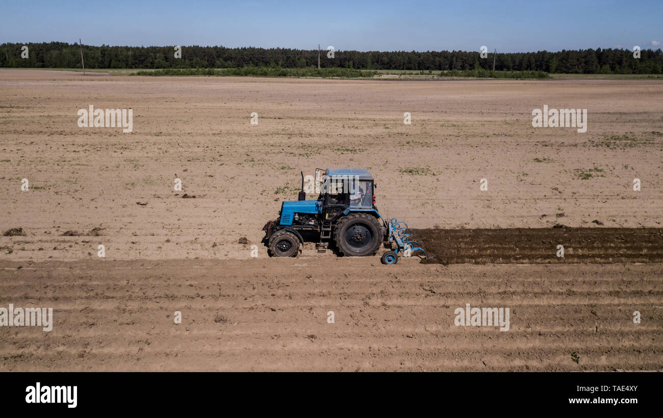tractor - aerial view of a tractor at work - cultivating a field in ...