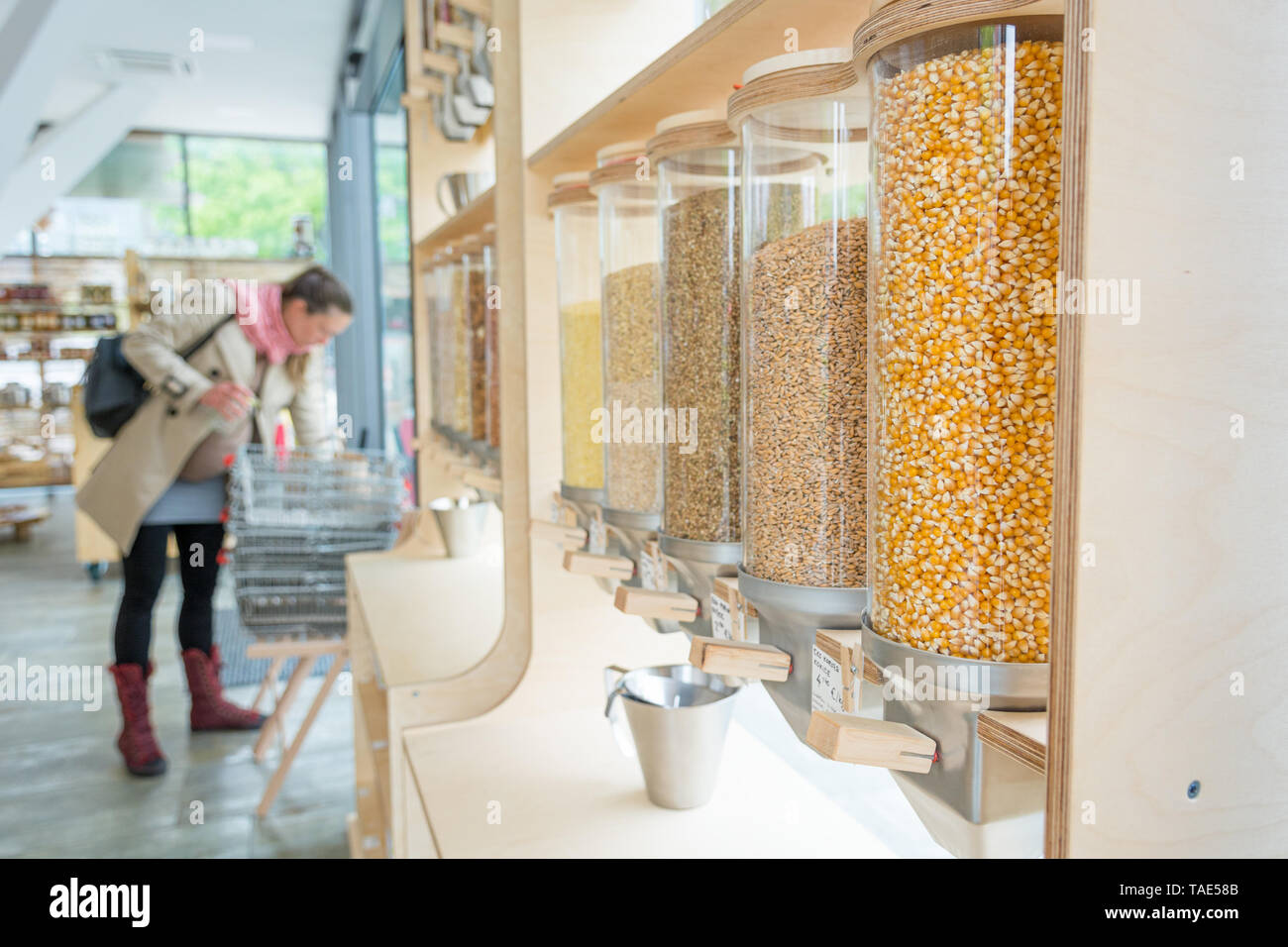 Unrecognizable female shopper in zero waste shop with many bulk ...