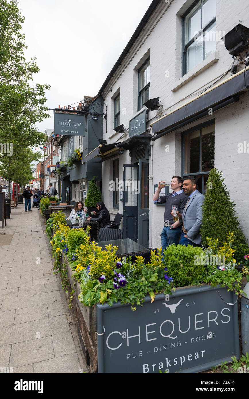 People socialising and enjoying refreshments outside the Chequers and ...
