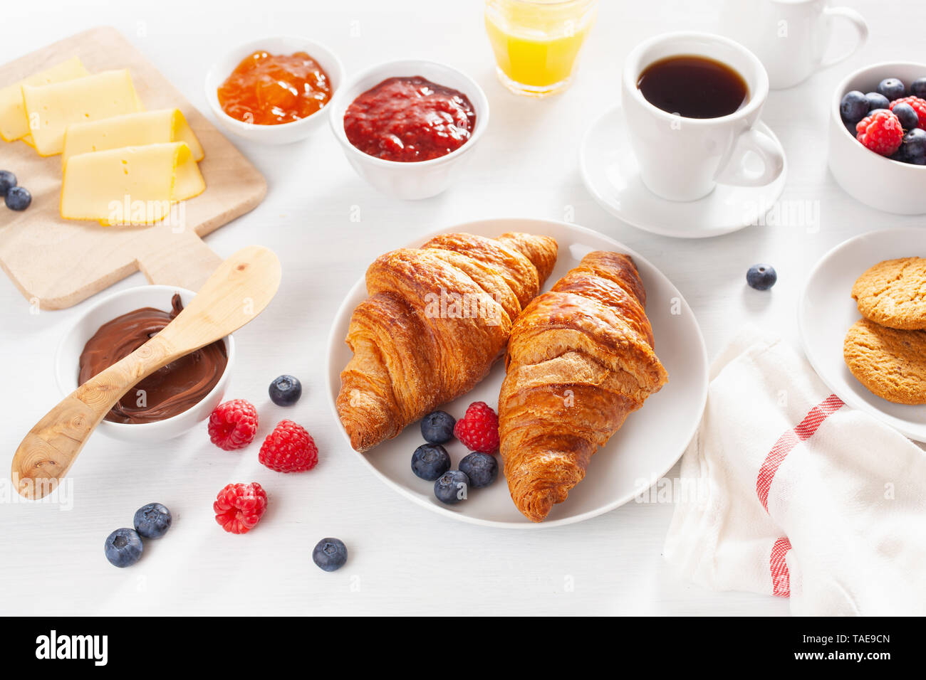 Continental breakfast with croissant, jam, chocolate spread and coffee ...