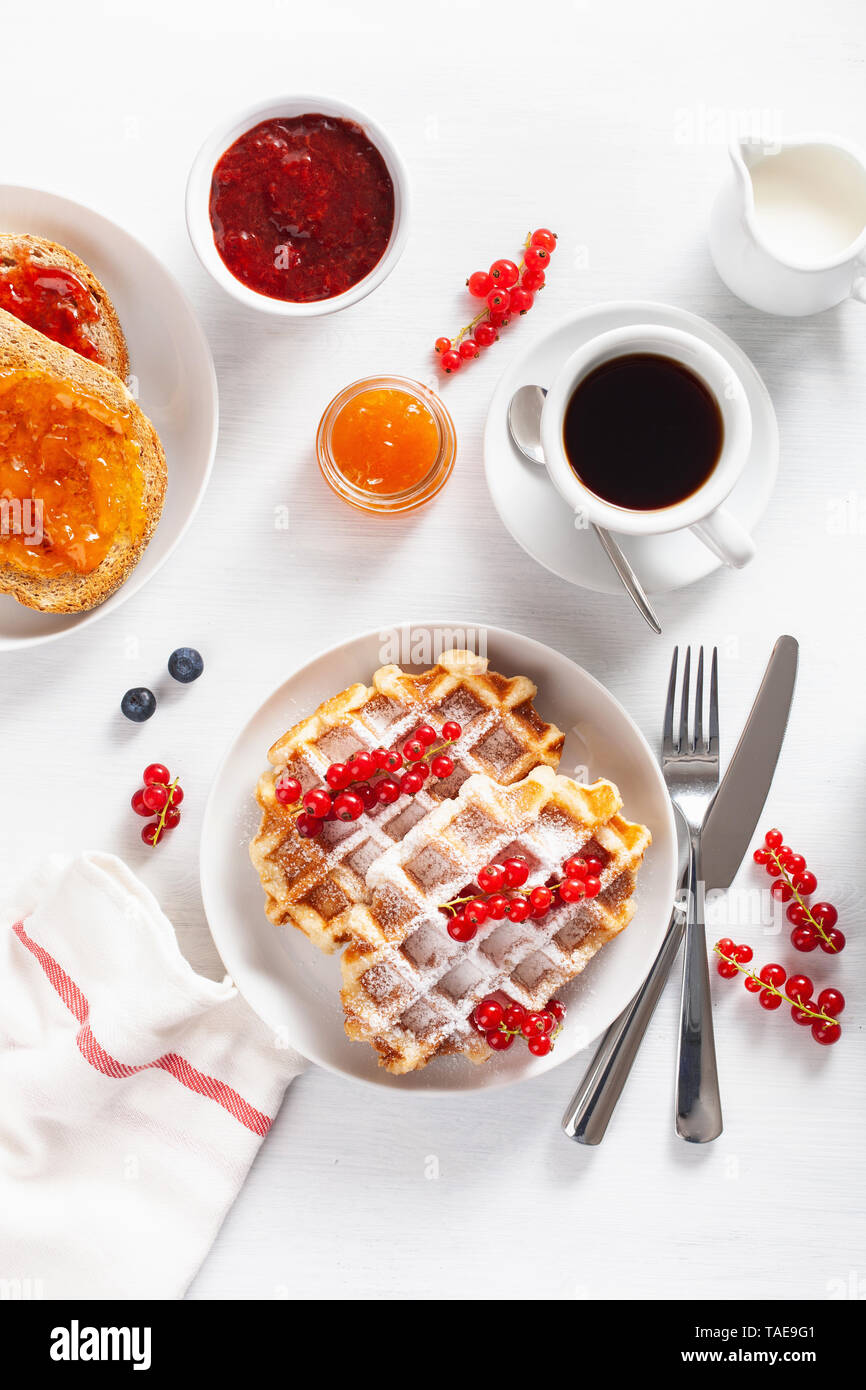 breakfast with waffle, toast, berry, jam, chocolate spread and coffee ...