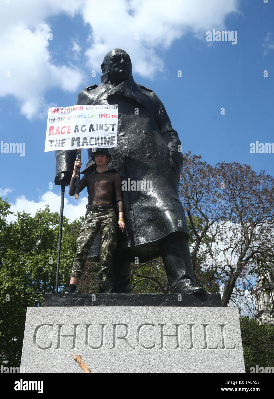 A climate change protestor climbs on the Winston Churchill statue in ...