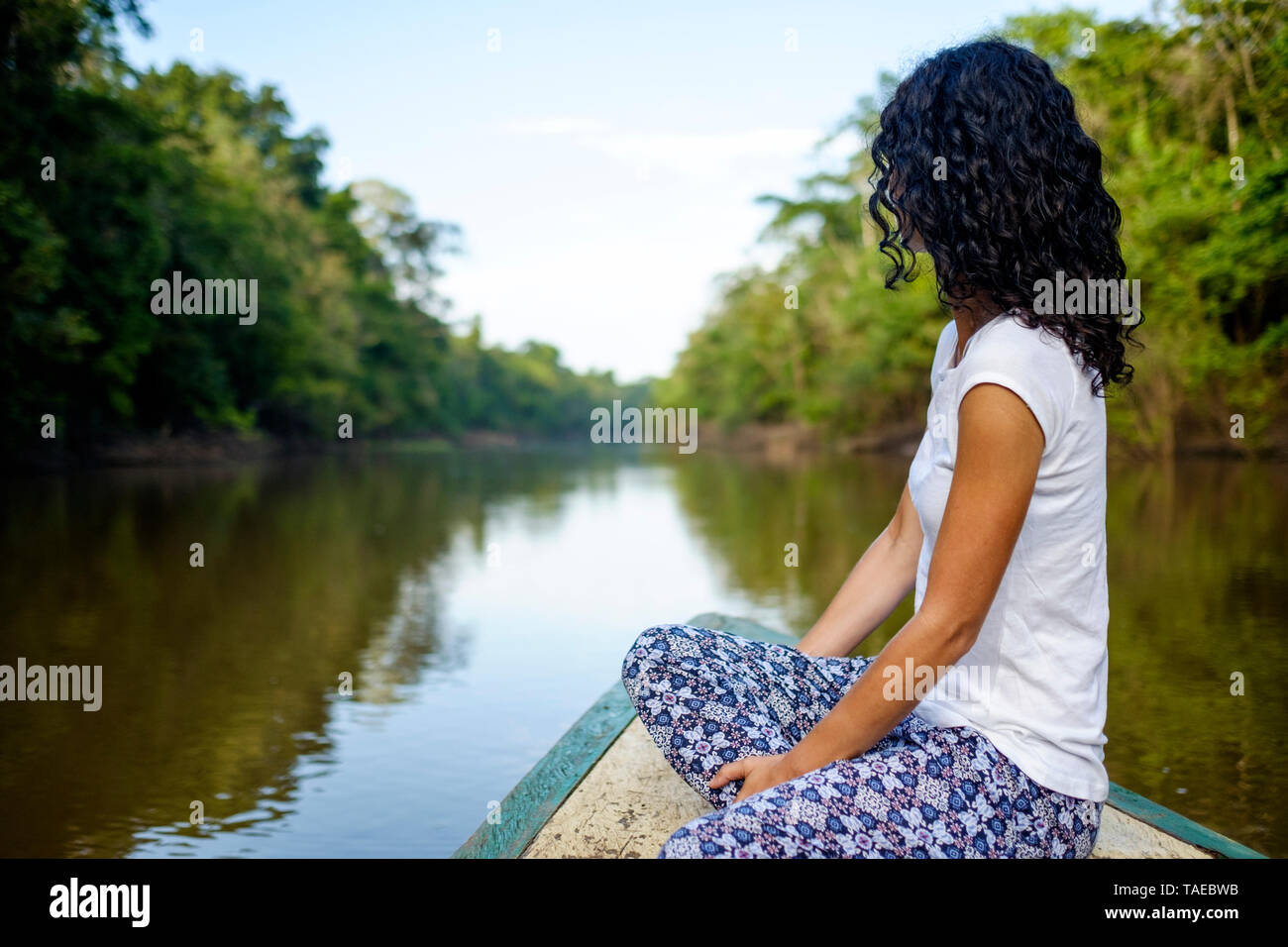 White tourist woman on a boat on the river going through the Amazon ...