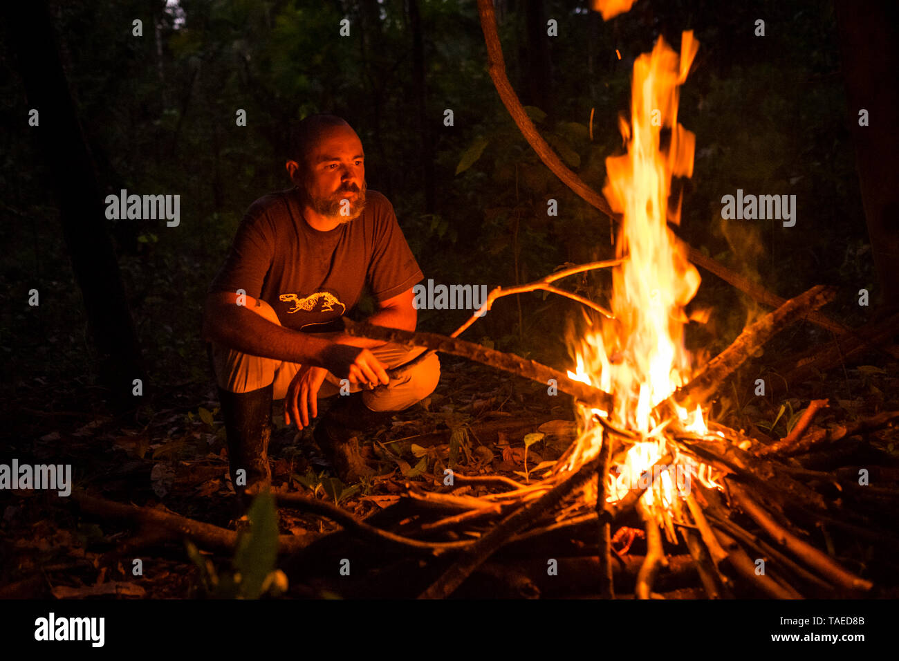Man enjoying a bonfire on the Amazon jungle at night, Loreto Department ...
