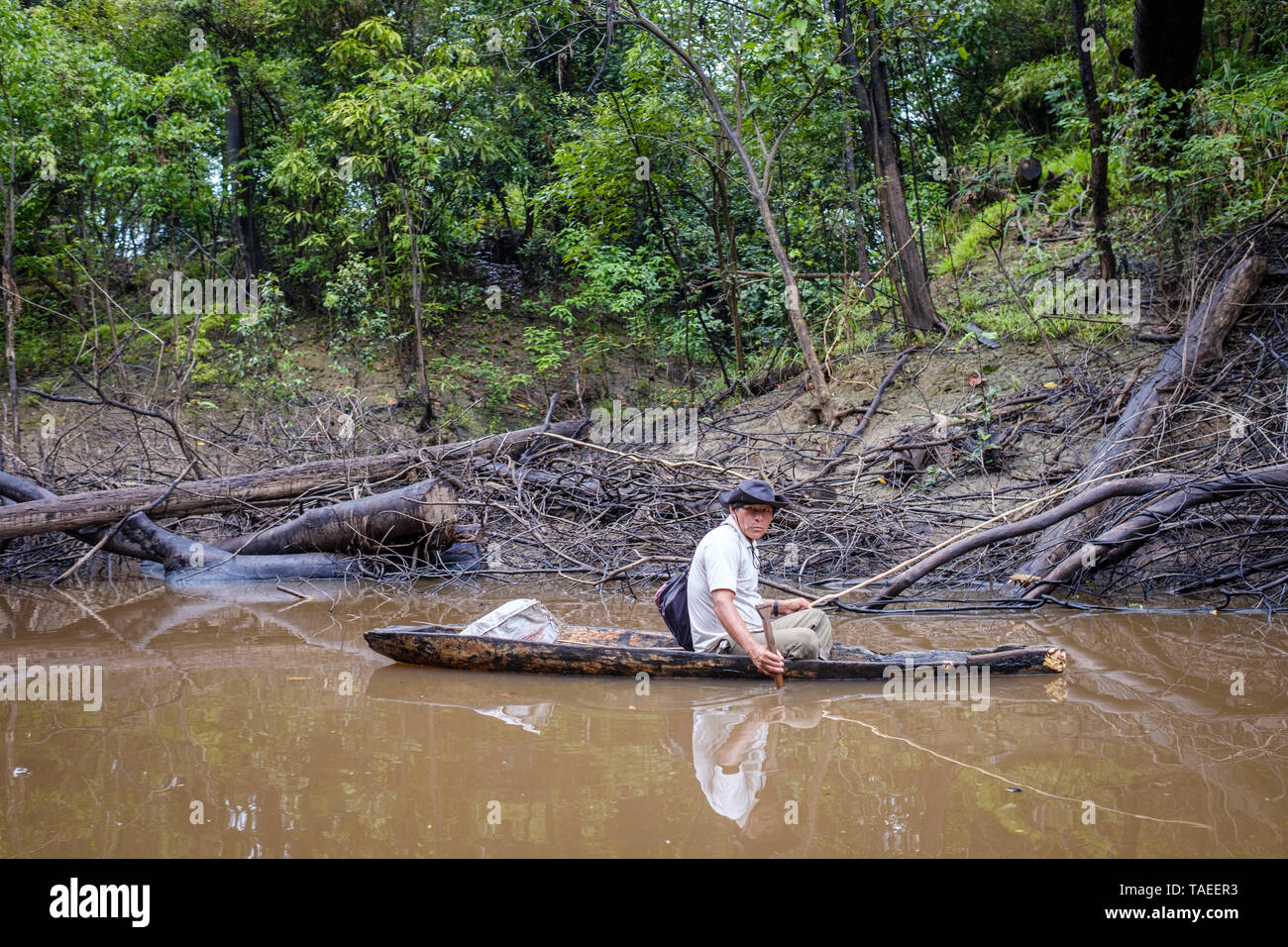Local man on a wooden boat on the Yanayacu River through the Amazon ...