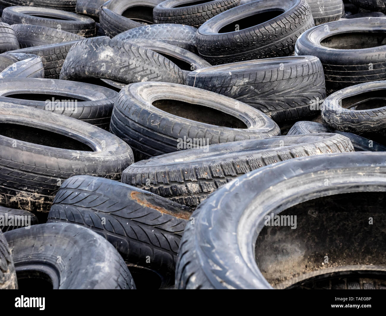 Large pile of tires dump. Illegal garbage dump. The concept of ecology ...