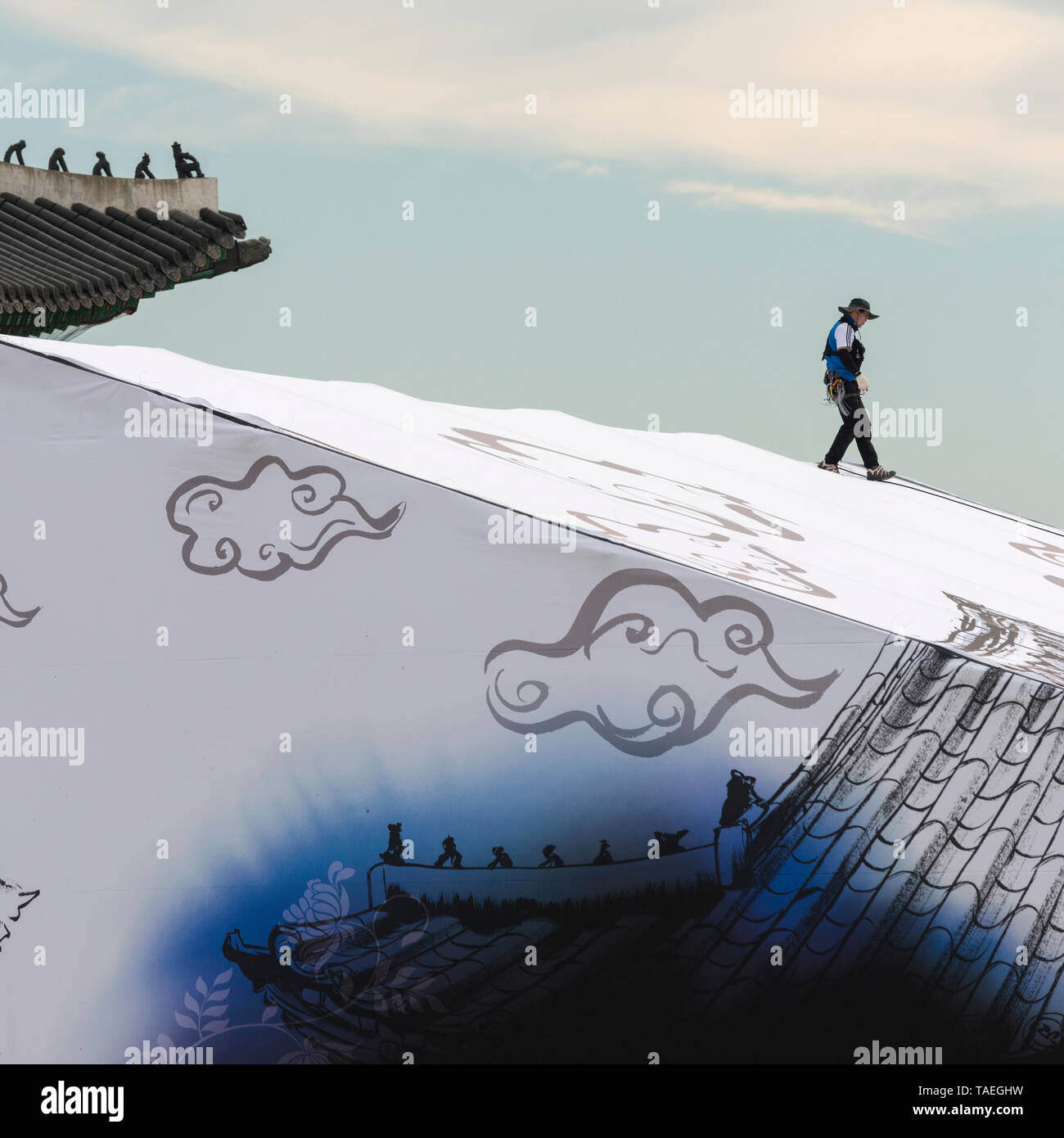 Man walking on the rooftop of traditional watchtower, Dongsibjagak ...