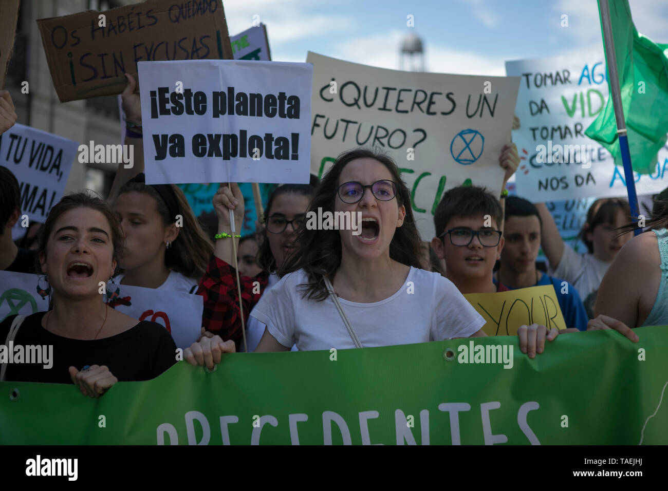 Students are seen shouting slogans while holding a banner and placards ...