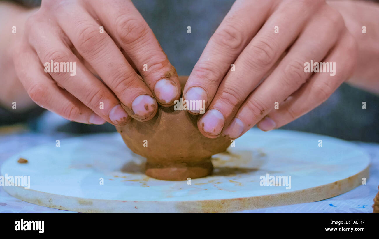 Professional male potter making mug in pottery workshop Stock Photo - Alamy