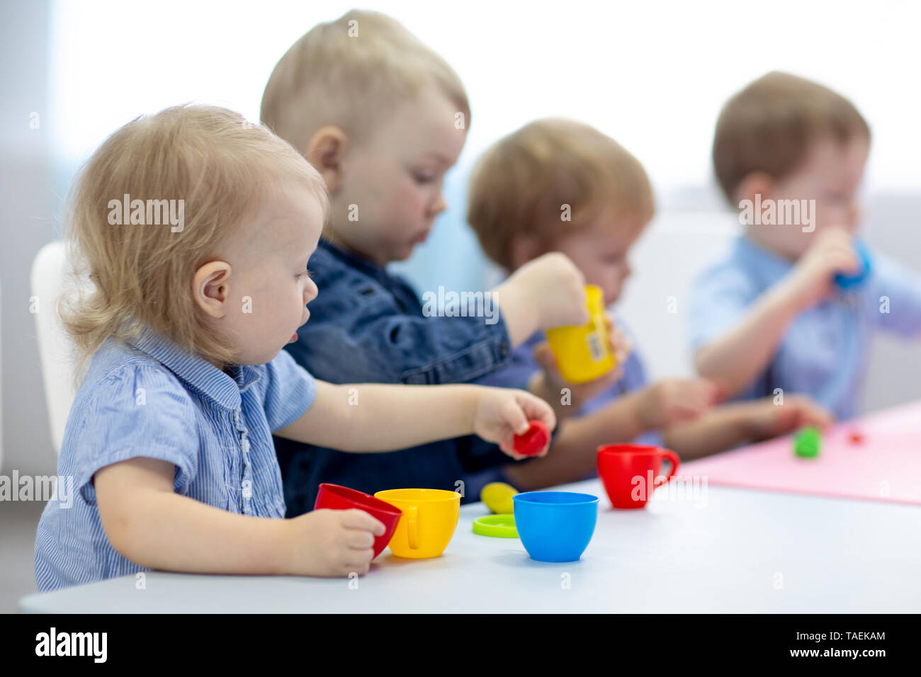 babies group learning arts and crafts in playroom with interest Stock ...