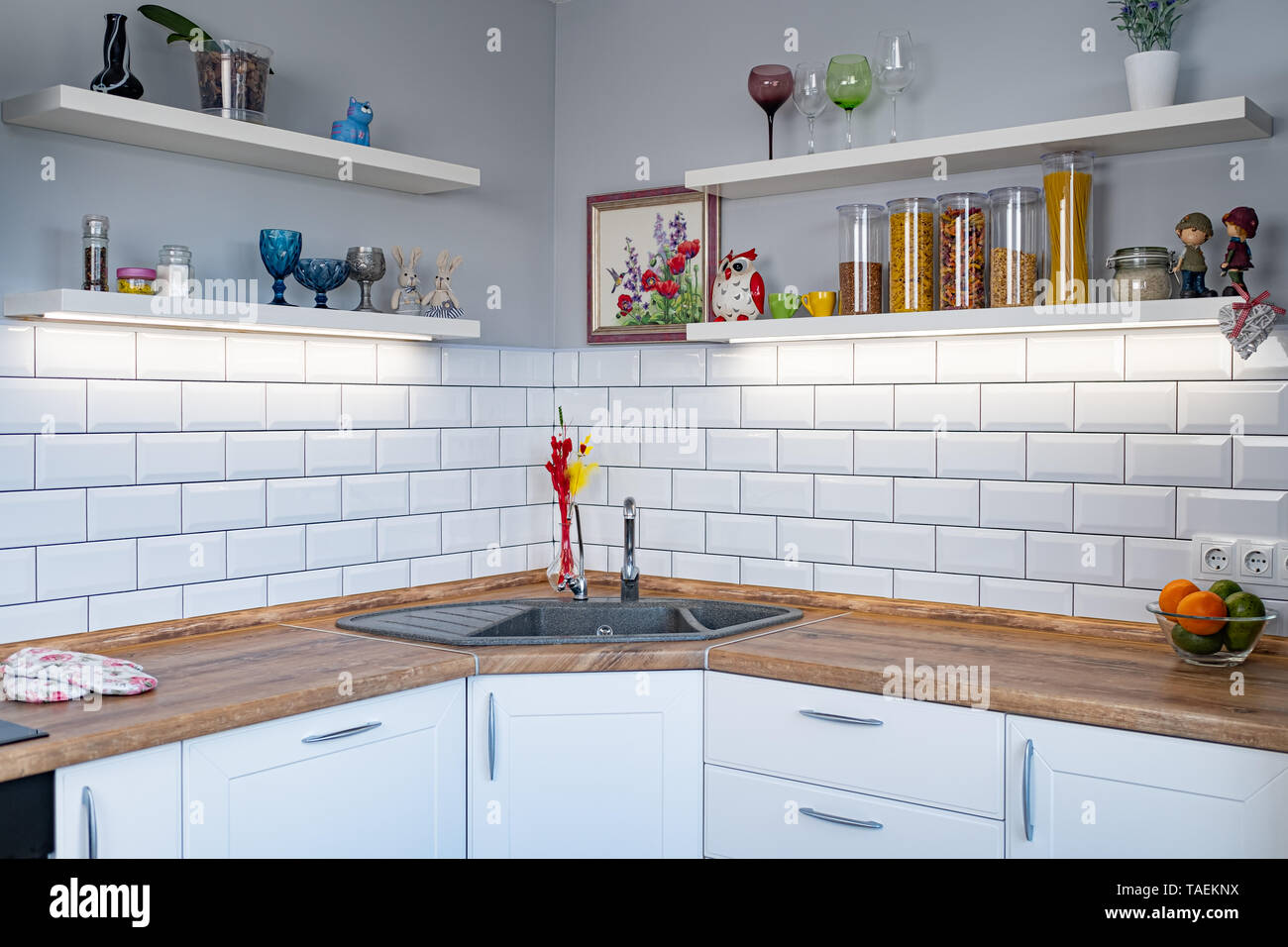 Kitchen bench shelves with various food ingredients on white ...