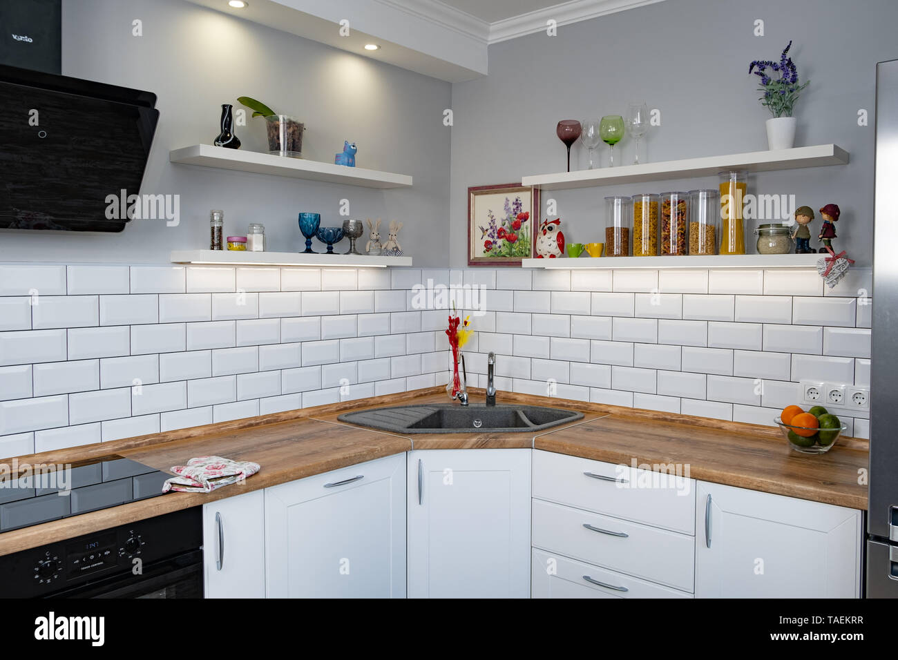 Kitchen bench shelves with various food ingredients on white ...