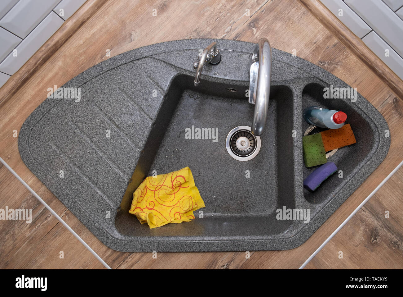 Stone sink made of granite square in gray color. wooden table top. view ...