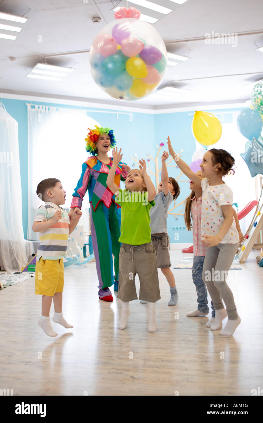 holidays, childhood and celebration concept - happy kids having fun and ...