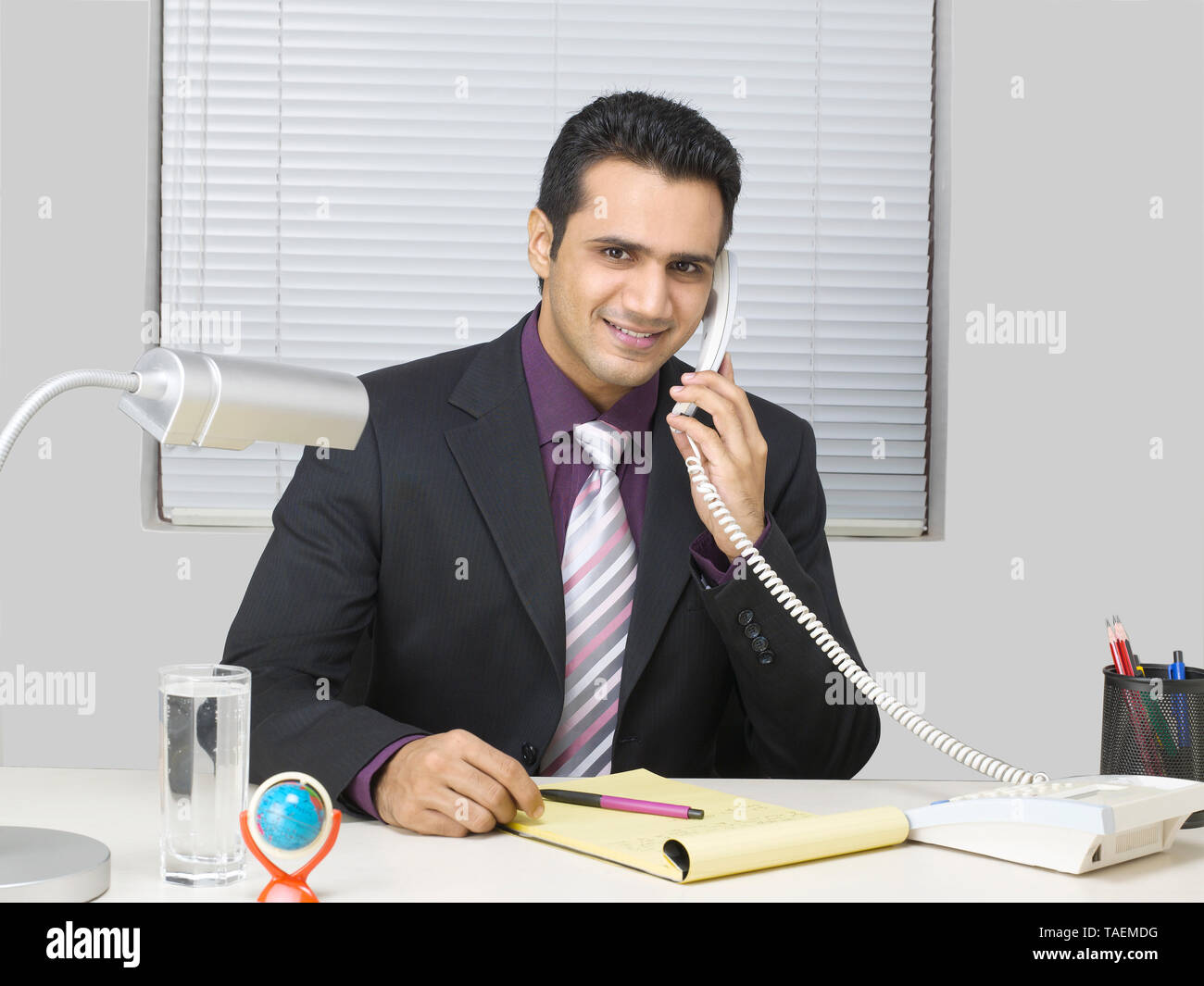 CORPORATE EXECUTIVE TALKING ON A LAND LINE TELEPHONE Stock Photo - Alamy