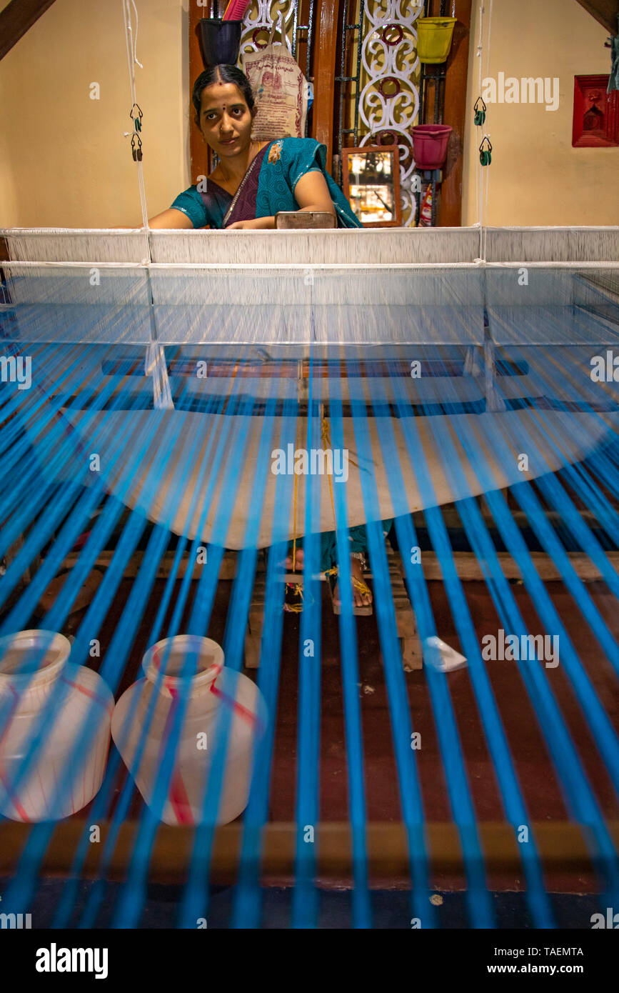 Vertical portrait of a lady working at a floor loom in India Stock ...