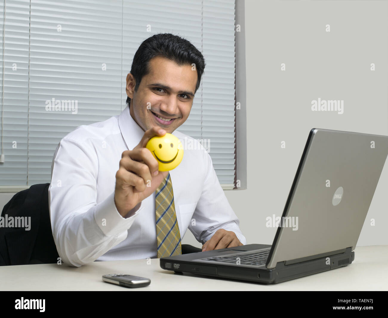 PORTRAIT OF CORPORATE EXECUTIVE holding a smiley ball Stock Photo - Alamy