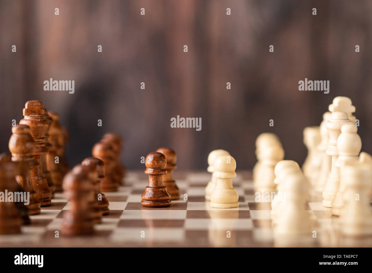 wooden chess endways on the board with wood background. Select focus ...