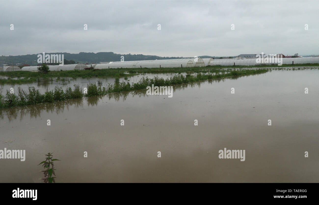 View of rural farm flooding featuring farm house, on dry flooded fields ...