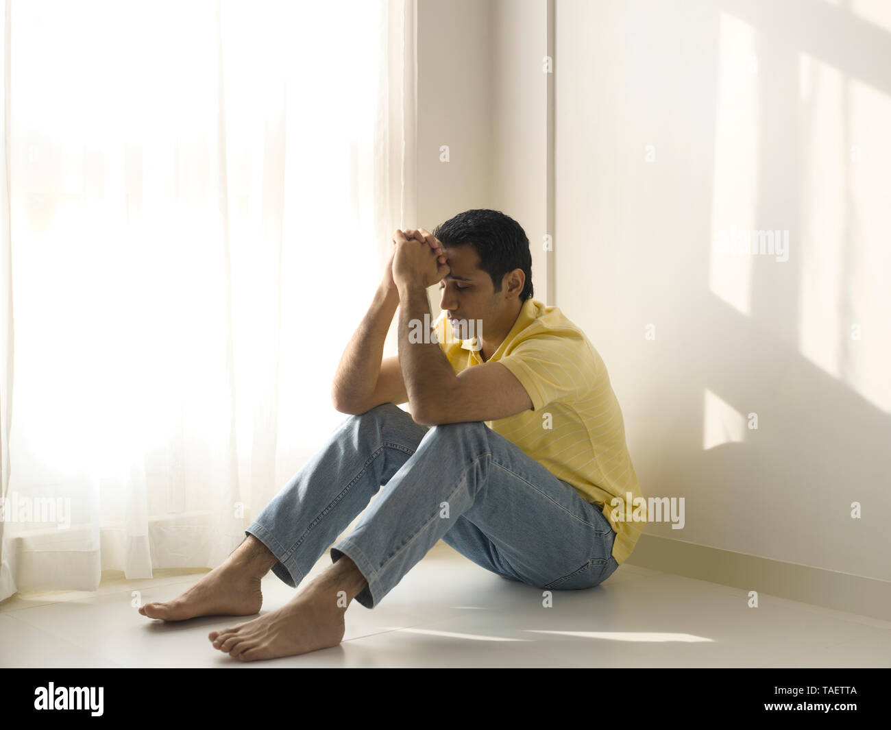 PORTRAIT OF A DEPRESSED MAN SITTING IN HIS HOME Stock Photo - Alamy