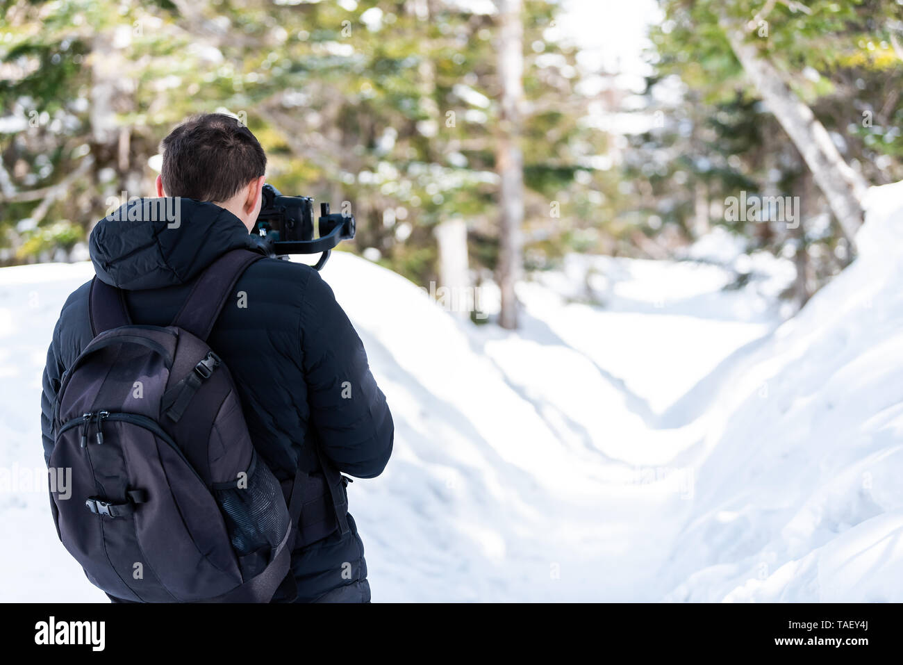 Takayama, Japan closeup of man taking picture of snow covered trail in ...