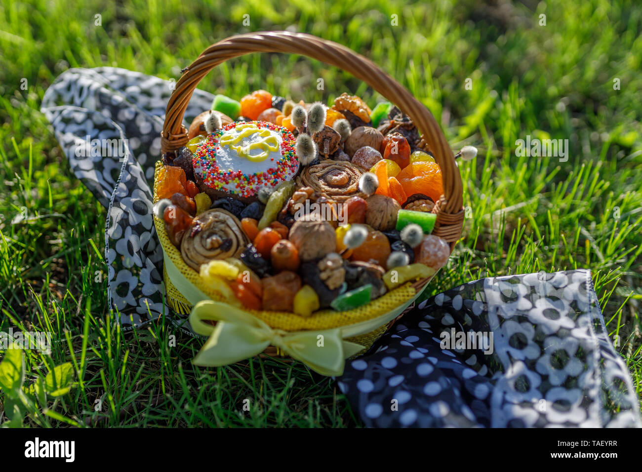 Basket with Easter cake, dried fruits and nuts on the green grass Stock ...
