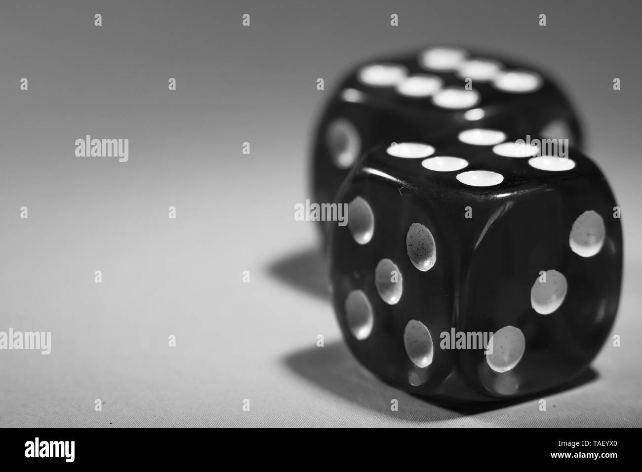 Closeup of a two black dice with a winning number on the top face on a ...