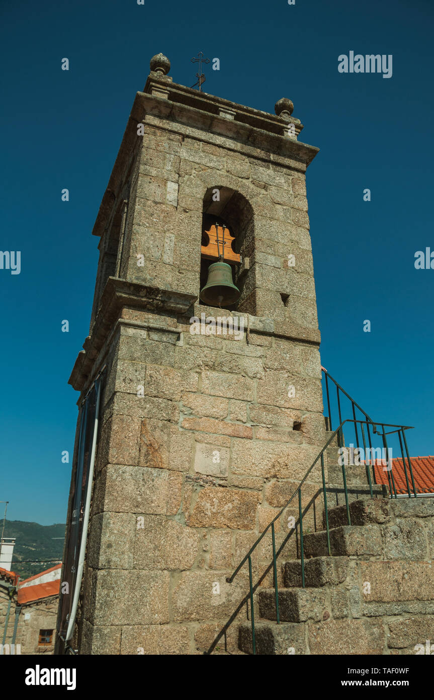 Medieval steeple made of stone with bronze bell and staircase with iron ...