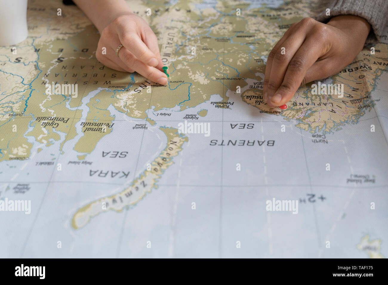 Friends putting pins on a map hi-res stock photography and images - Alamy