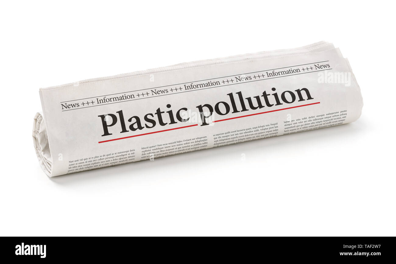 Rolled newspaper with the headline Plastic pollution Stock Photo - Alamy